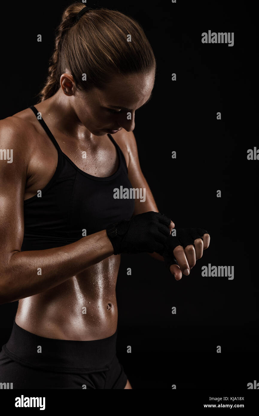 Shot of a beautiful fit young woman getting ready for a kickbox workout ...