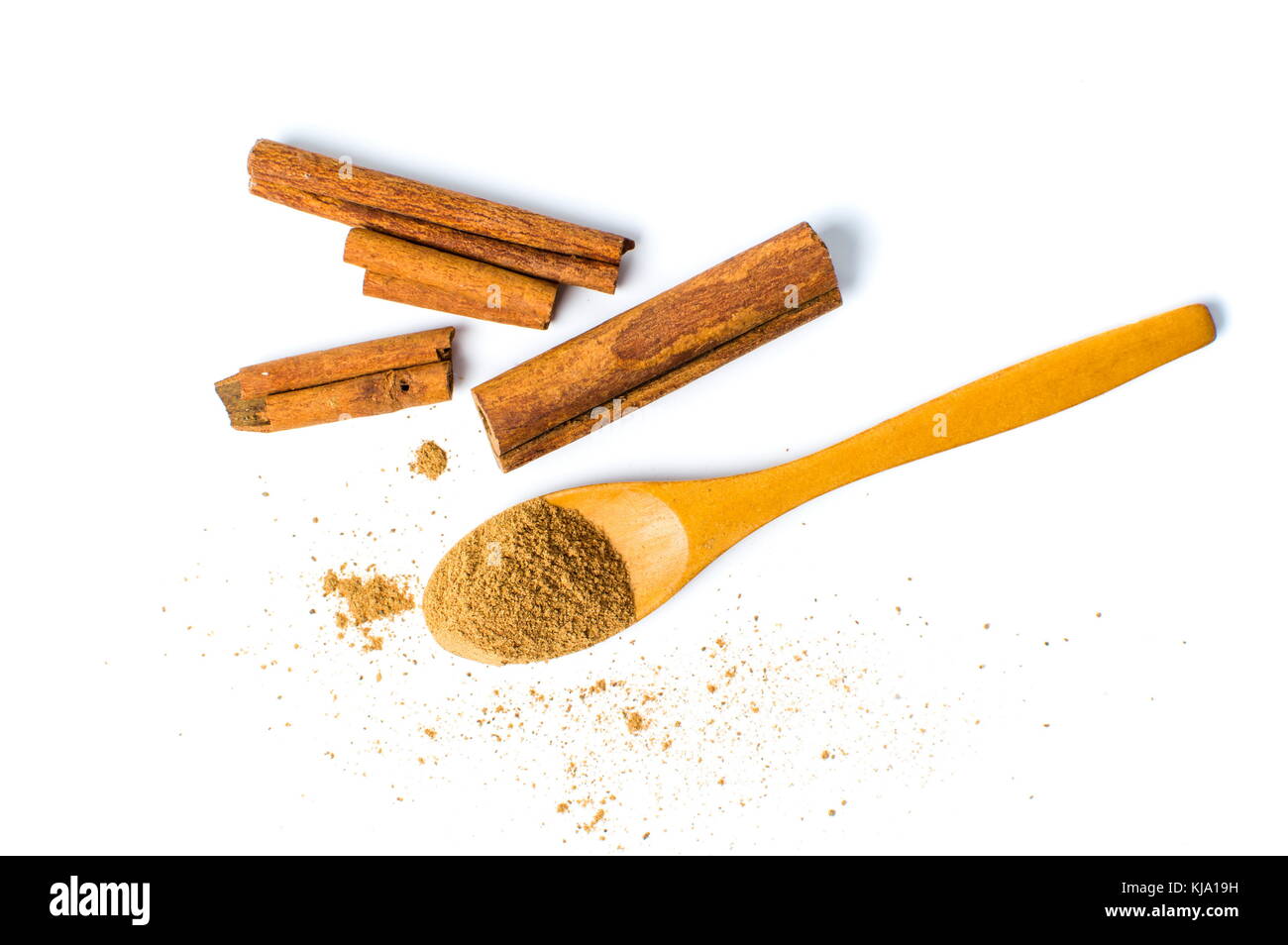 Cinnamon powder in a spoon and sticks isolated Stock Photo - Alamy
