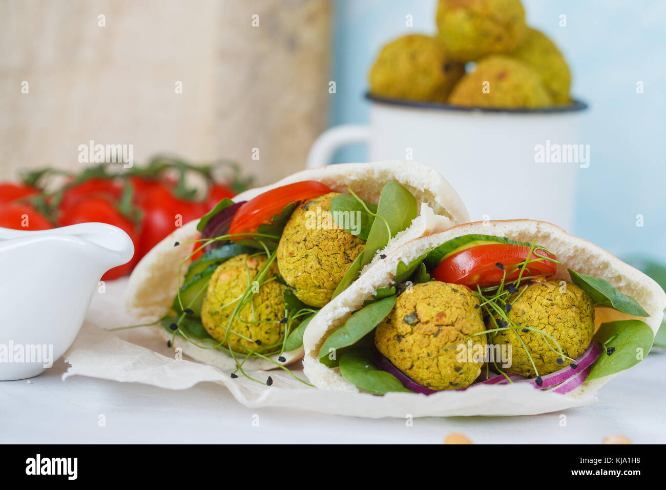 Baked falafel and fresh vegetables in pita bread, light background ...
