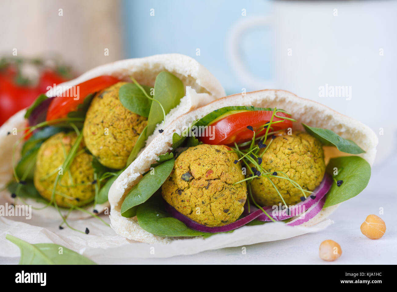Baked falafel and fresh vegetables in pita bread, light background ...