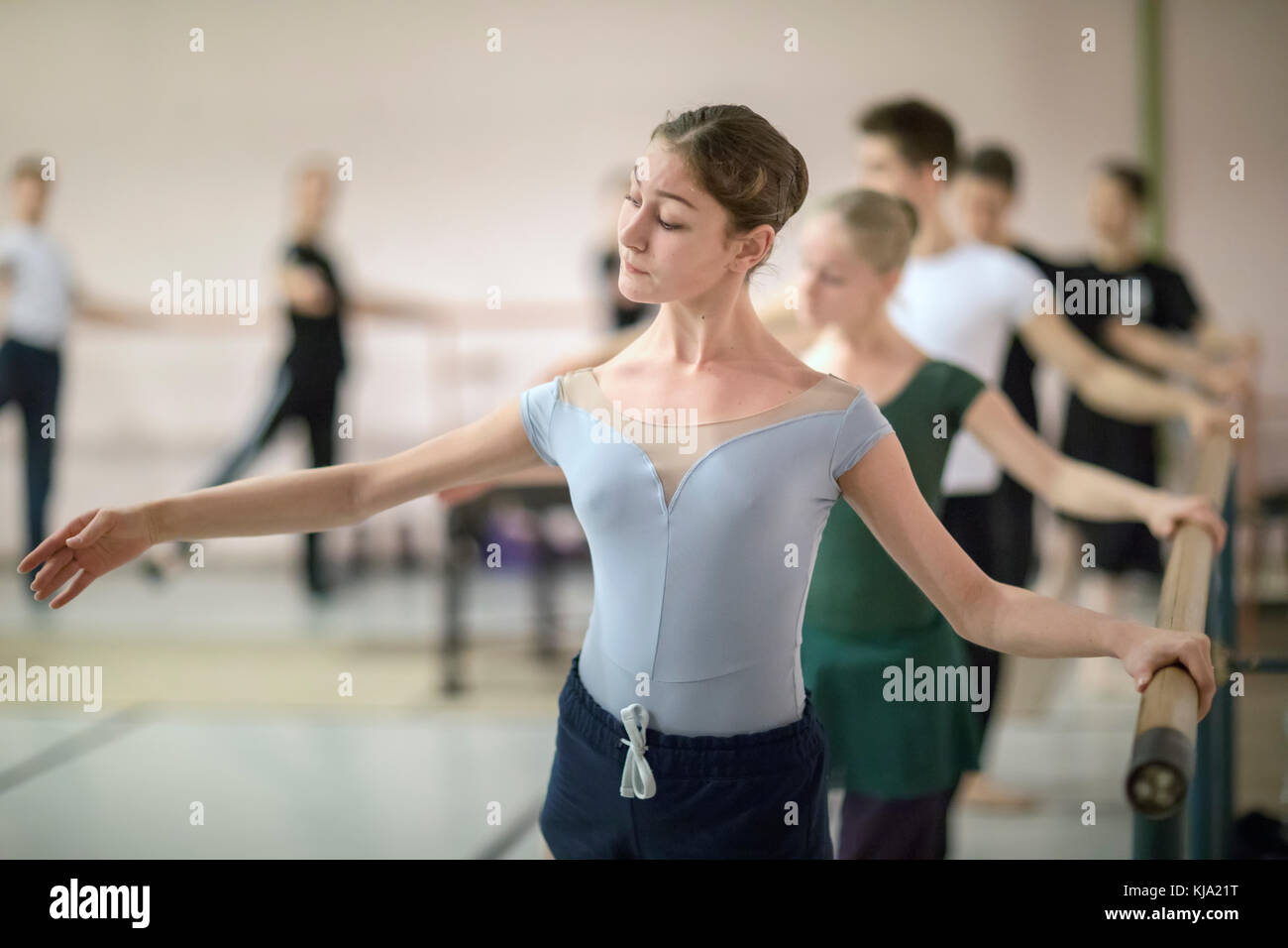 Participants of All-Russian ballet competition practicing at the bar ...