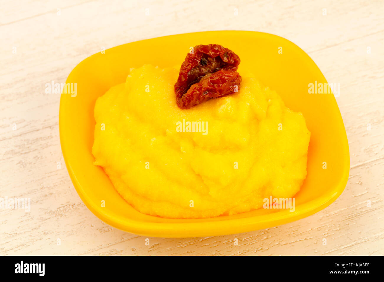 Polenta with dry tomato Stock Photo - Alamy