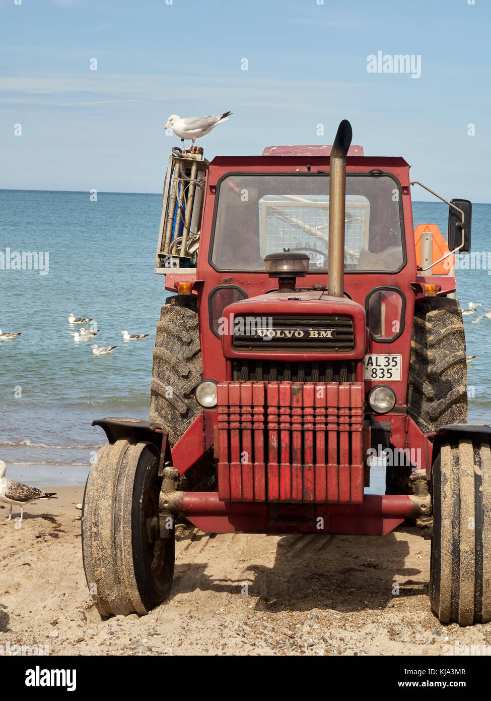 Tractor used for hauling fisher boats on the beach Stock Photo - Alamy