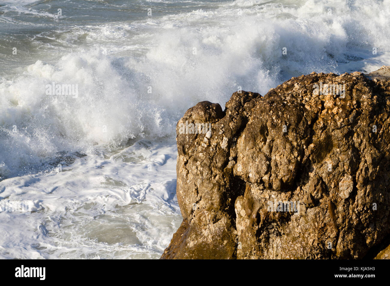 Wave crashing on rocks Stock Photo - Alamy