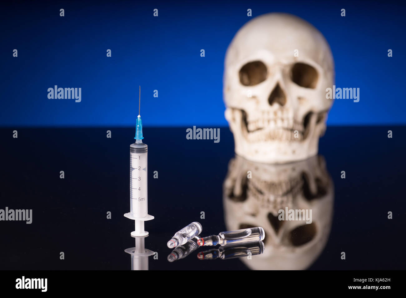 Skull and syringe, isolated on black blue background with glossy ...