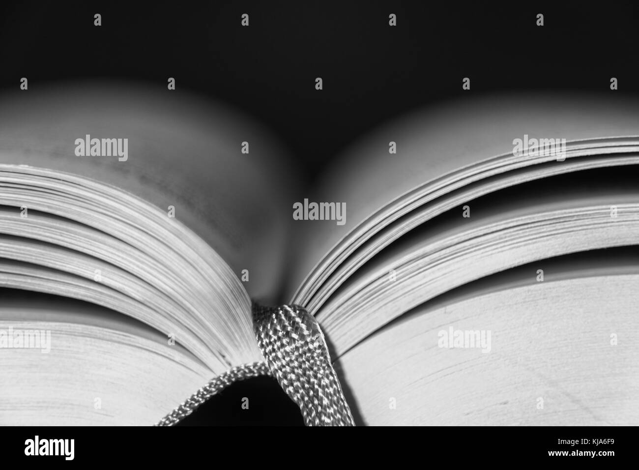 Open book with ribbon Stock Photo - Alamy