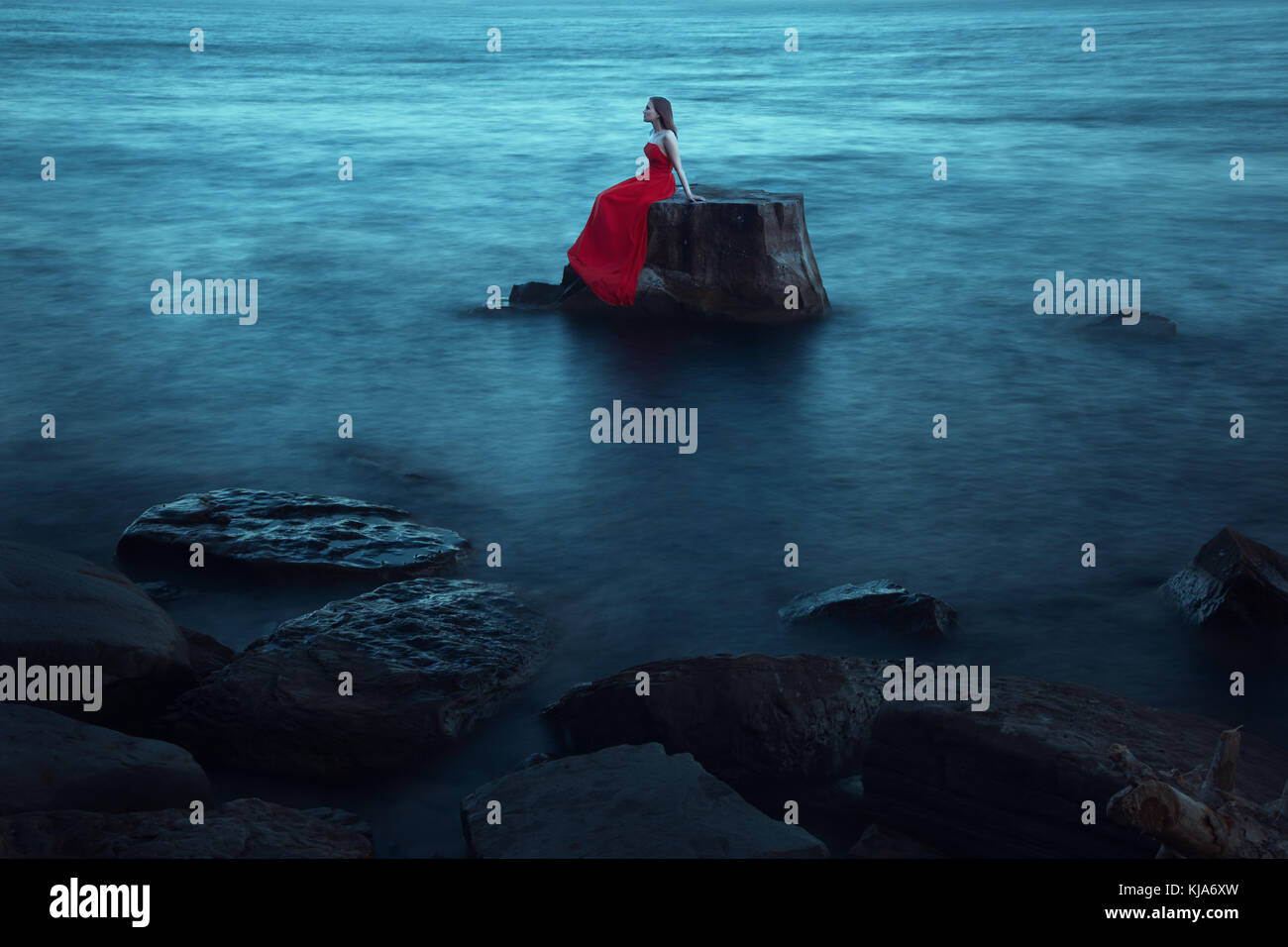 A sad woman near the sea in evening Stock Photo - Alamy