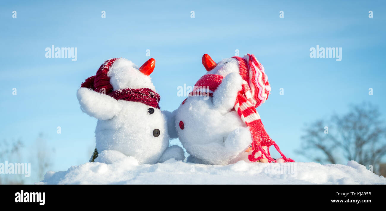 Couple of snowmen taking hand of each other Stock Photo - Alamy