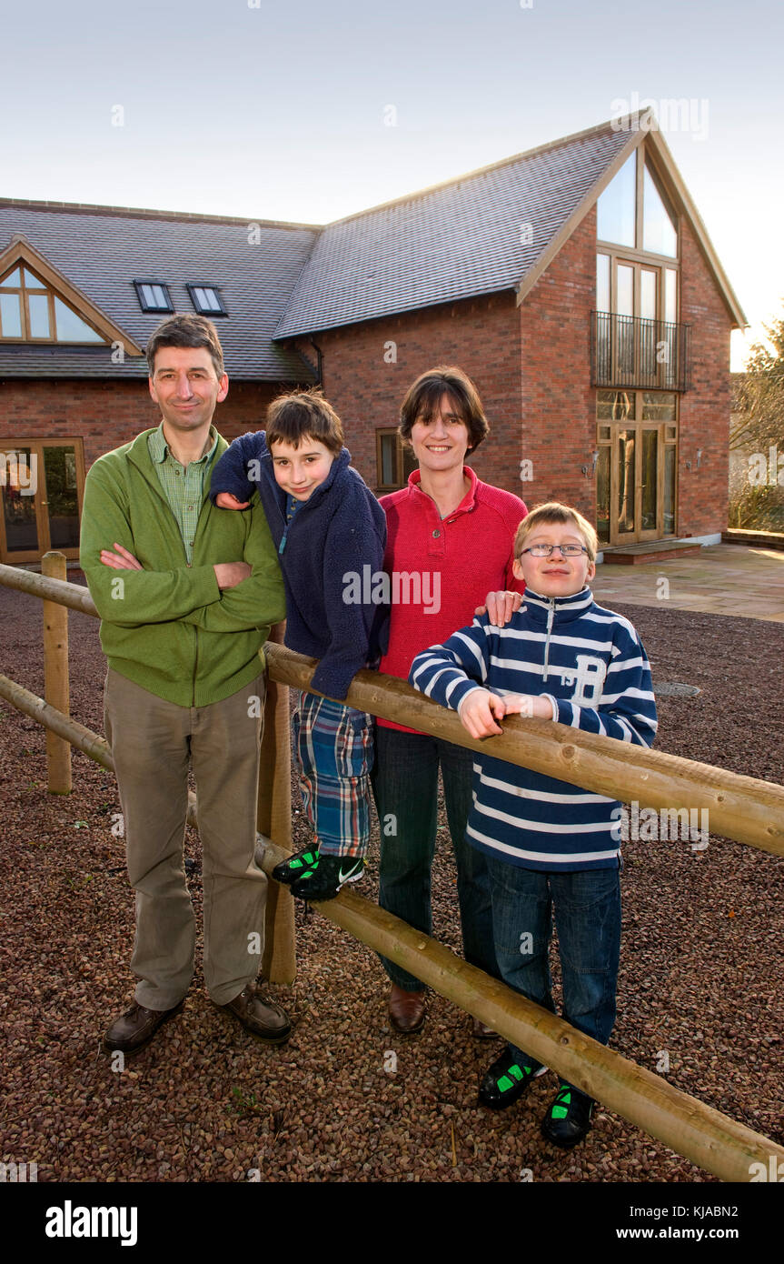 Family standing in front of house hi-res stock photography and images ...