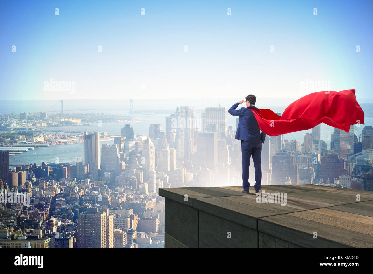 Super hero businessman on top of building ready for challenge Stock ...