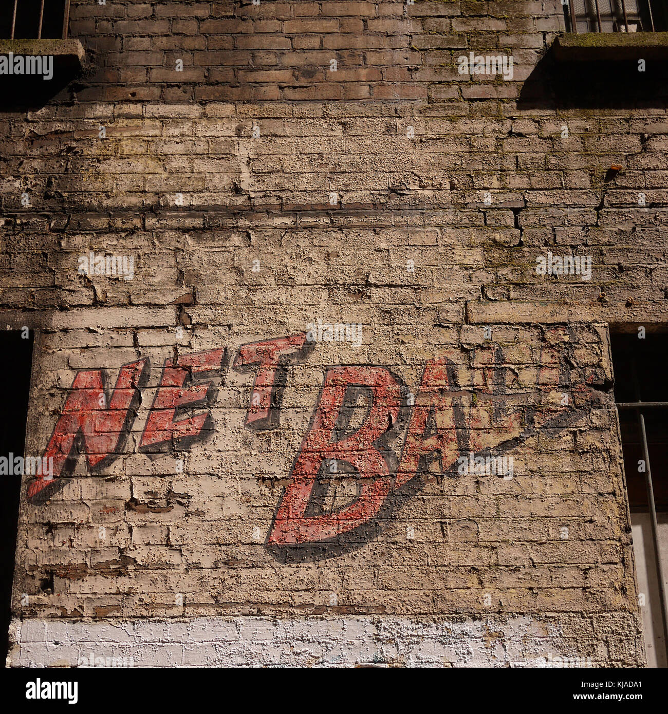 Brick work and old fashioned writing on a weathered wall Stock Photo ...