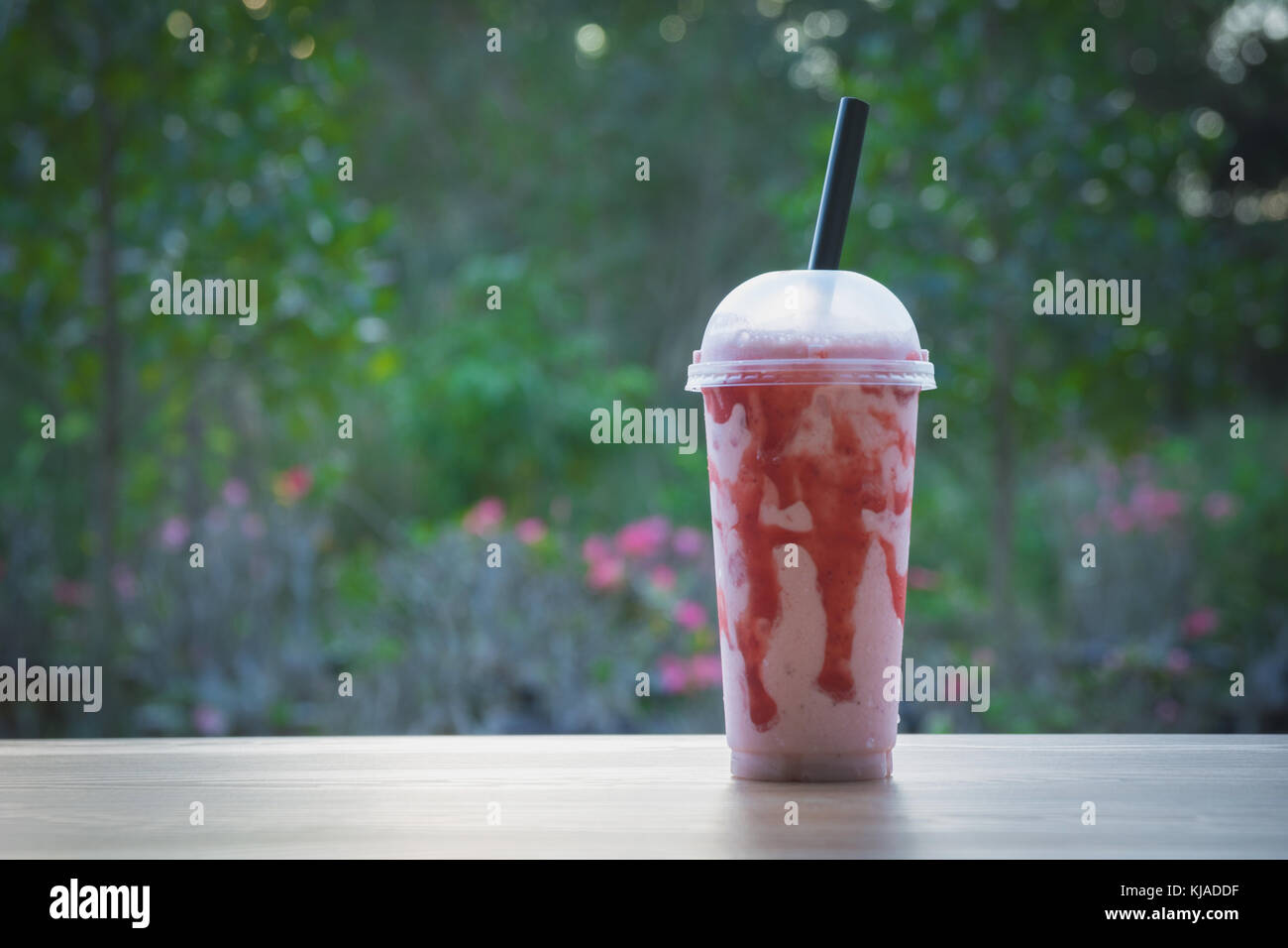 Red syrup water in glass isolated on nature background Stock Photo - Alamy