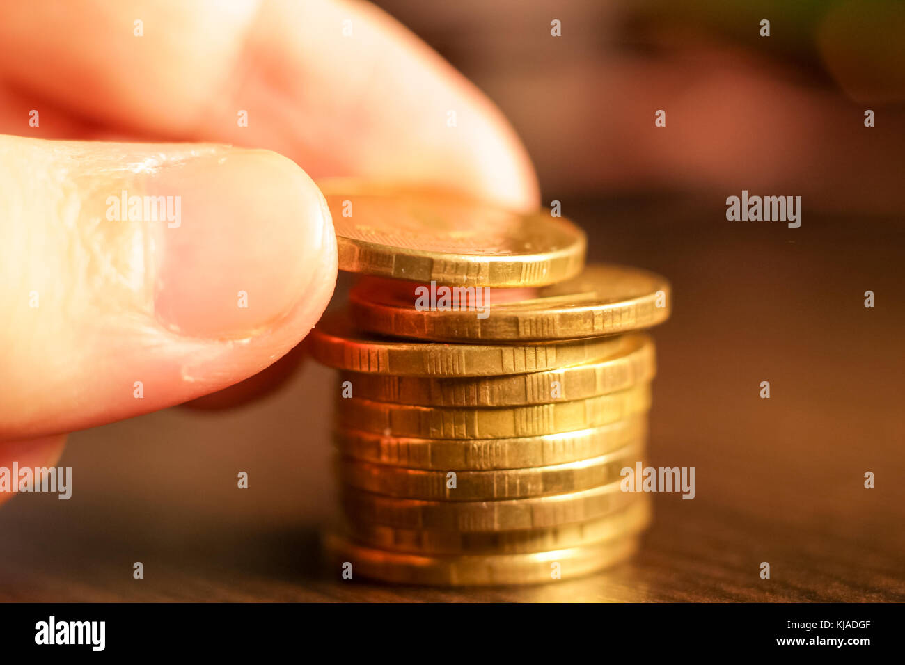 Hand making a pile of golden russian ruble coins . Russian currency ...
