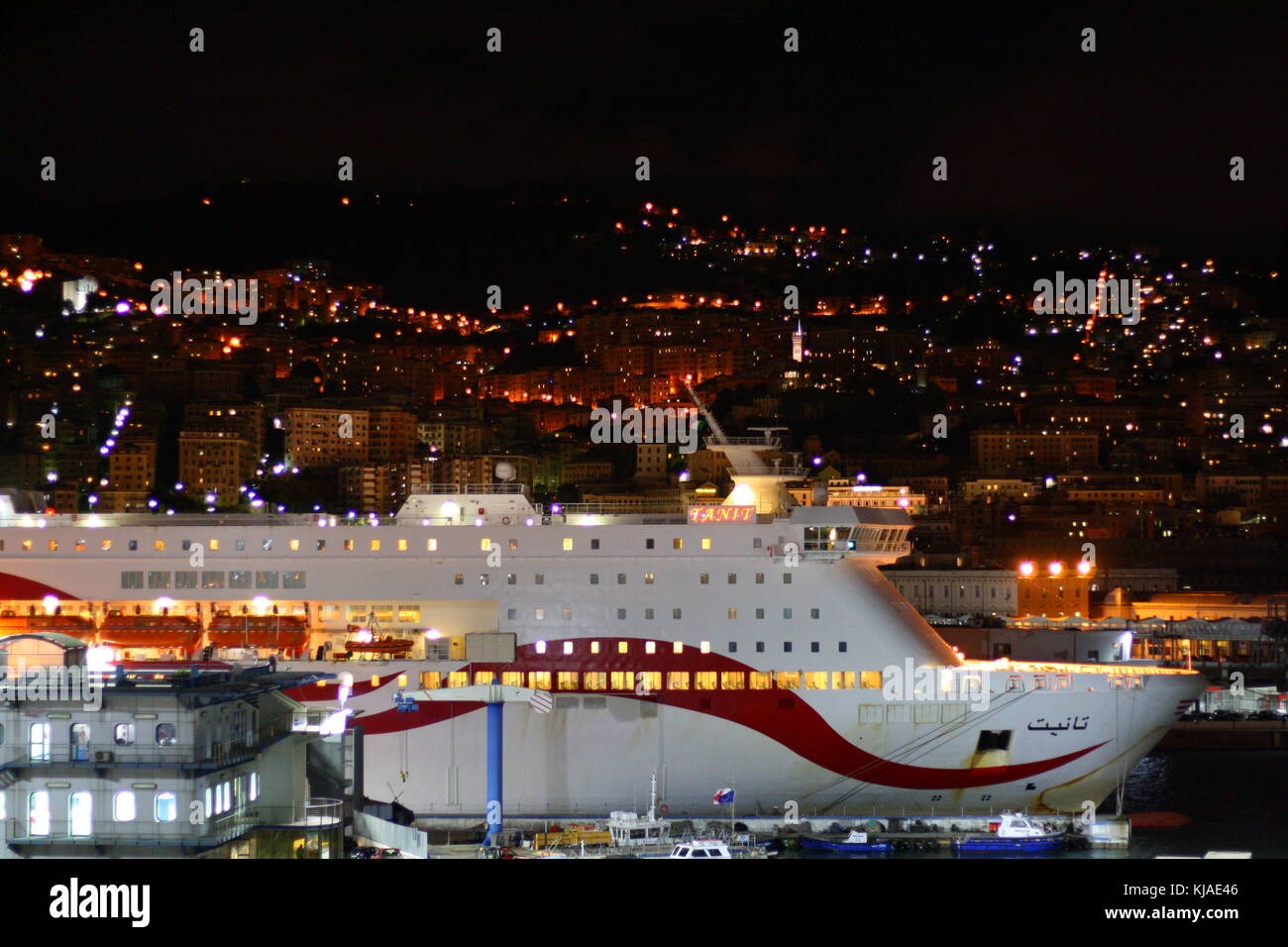 A giant ferry in the port of Genova, Italy, at night, ready to set sail ...