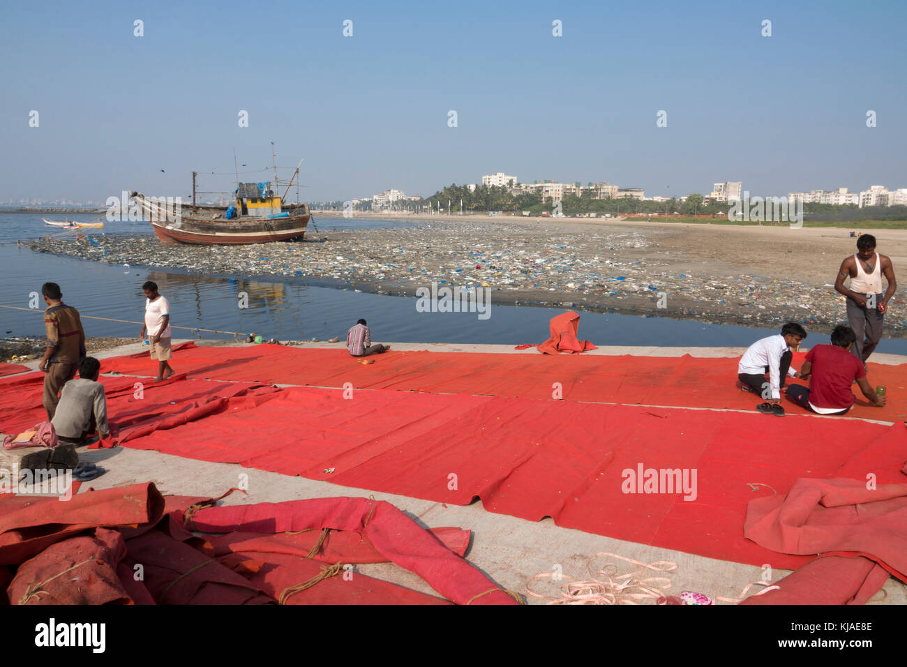 People working on textiles outside at Khar Danda in Mumbai, India Stock ...