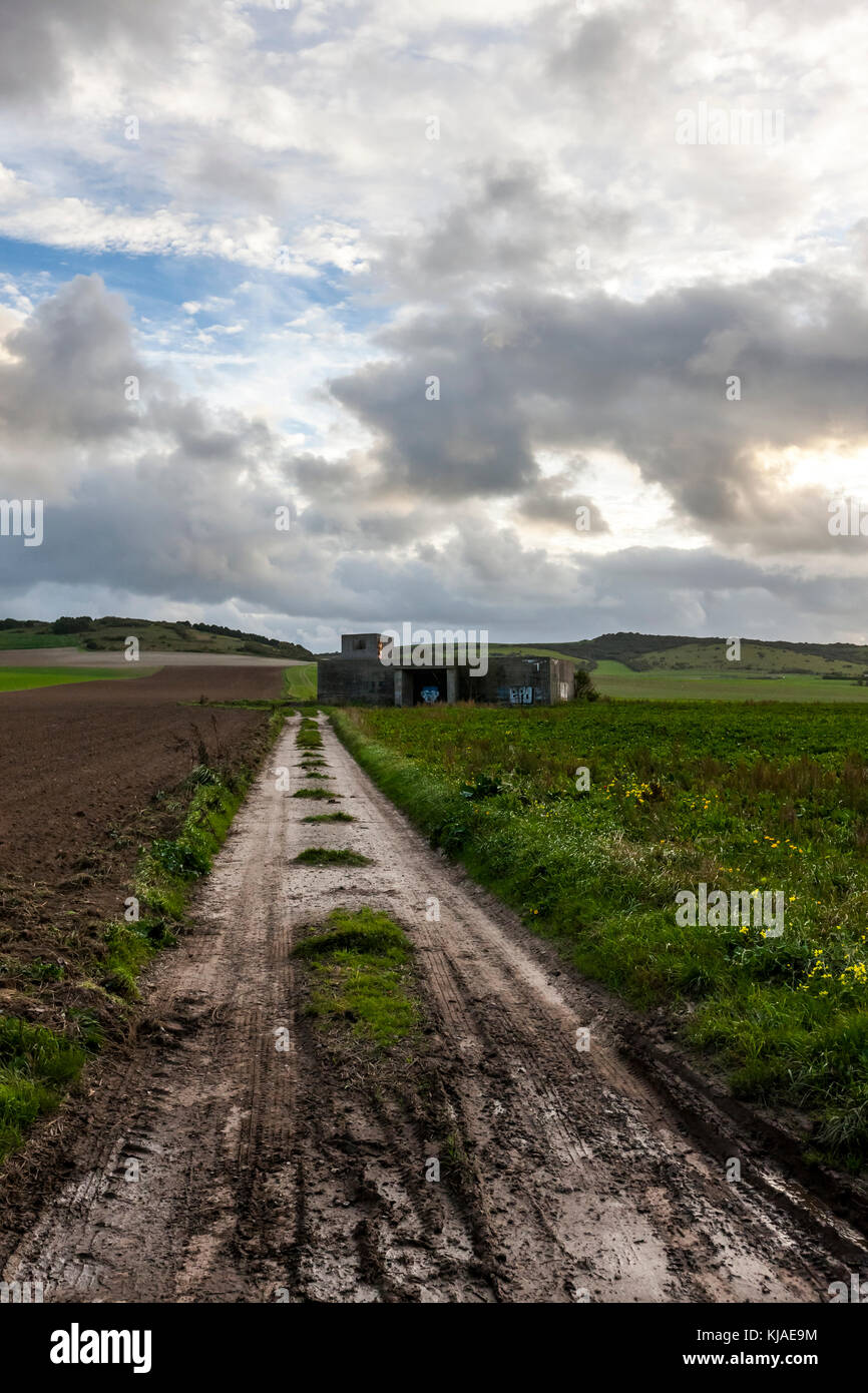Agricultural fields at sunset around an old World War 2 German bunker ...