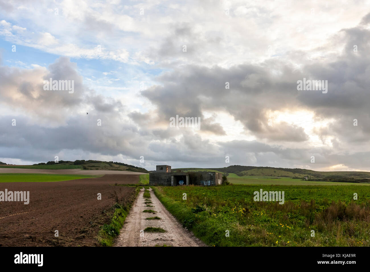 Agricultural fields at sunset around an old World War 2 German bunker ...