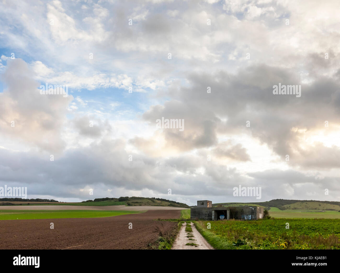Agricultural fields at sunset around an old World War 2 German bunker ...