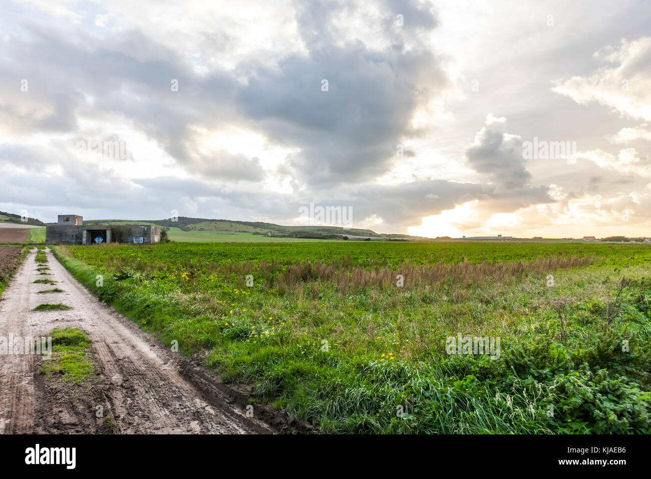 Agricultural fields at sunset around an old World War 2 German bunker ...