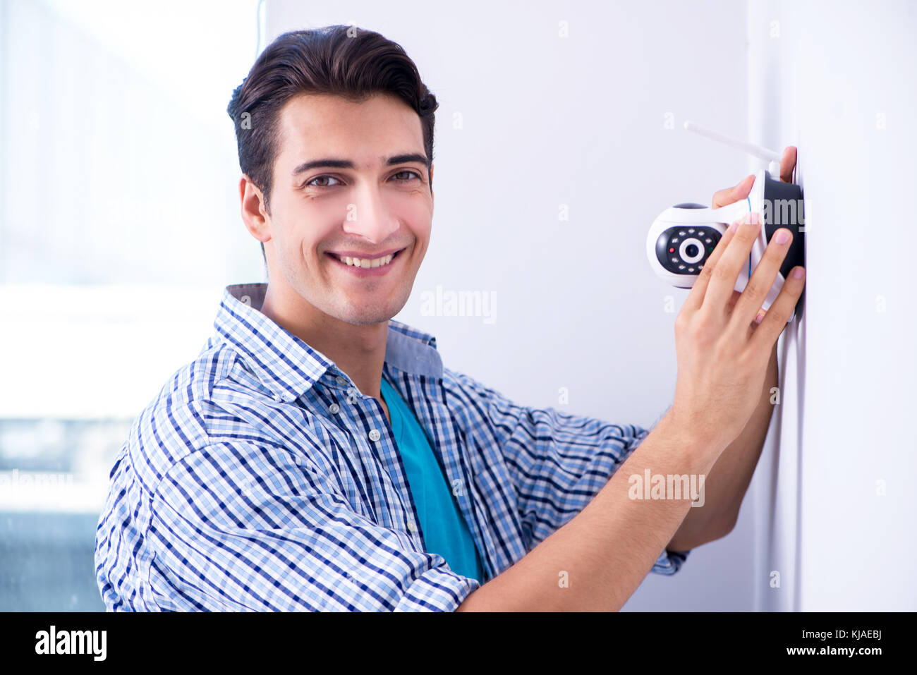 Man installing surveillance CCTV cameras at home Stock Photo - Alamy