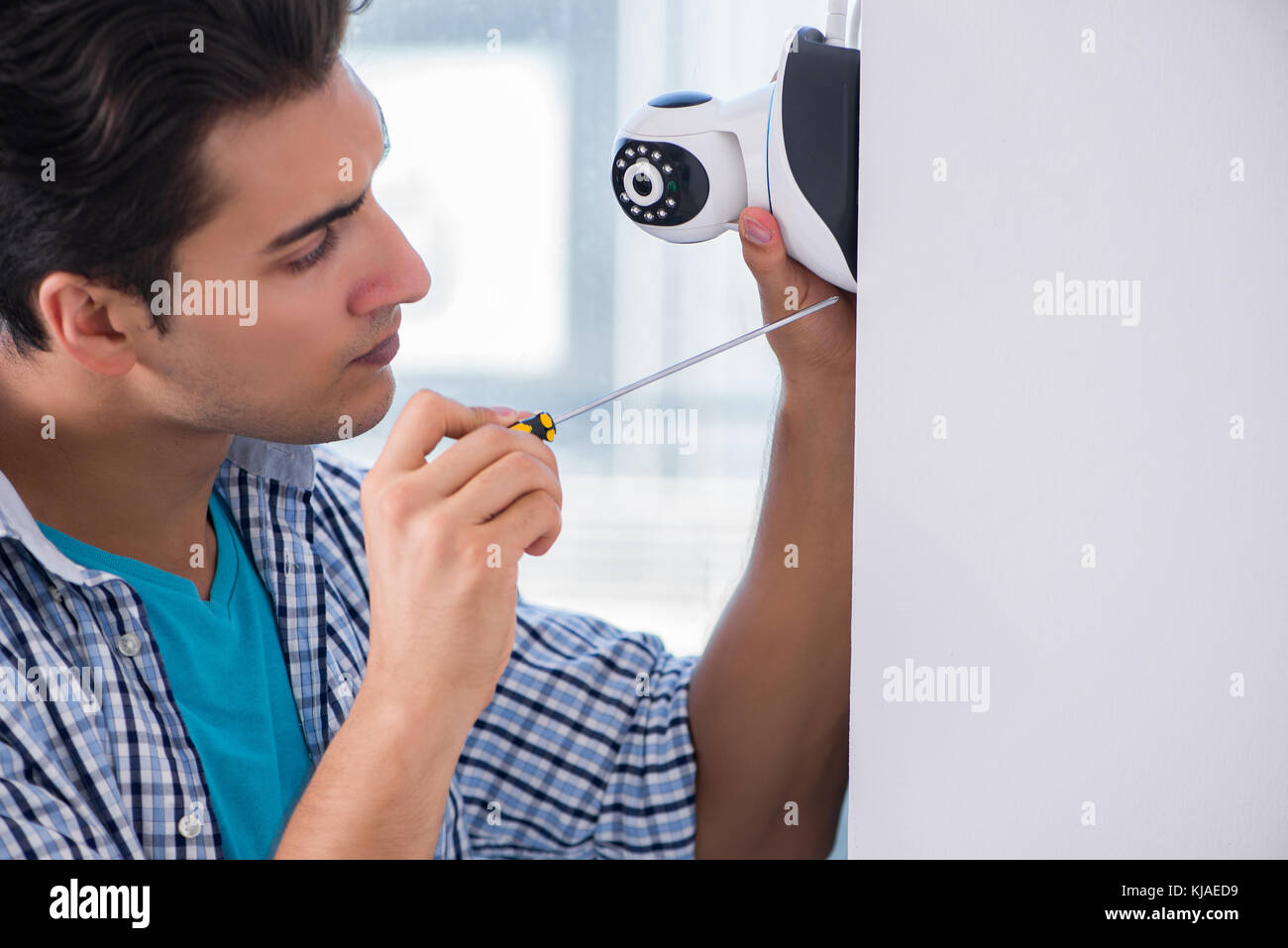 Man installing surveillance CCTV cameras at home Stock Photo - Alamy