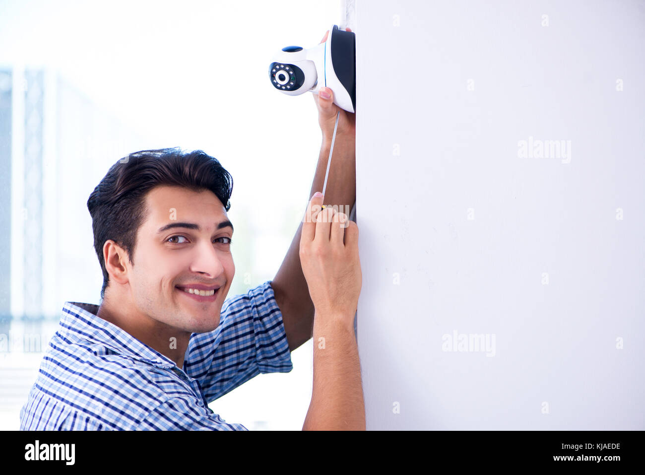 Man installing surveillance CCTV cameras at home Stock Photo - Alamy