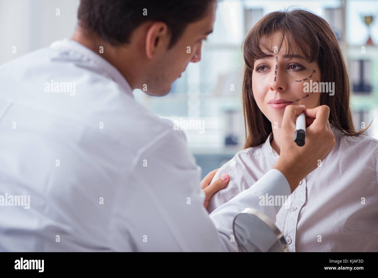 Plastic surgeon preparing for operation on woman face Stock Photo - Alamy