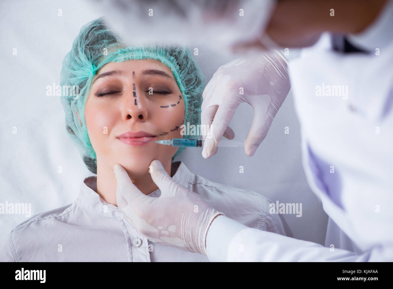 Plastic surgeon preparing for operation on woman face Stock Photo - Alamy