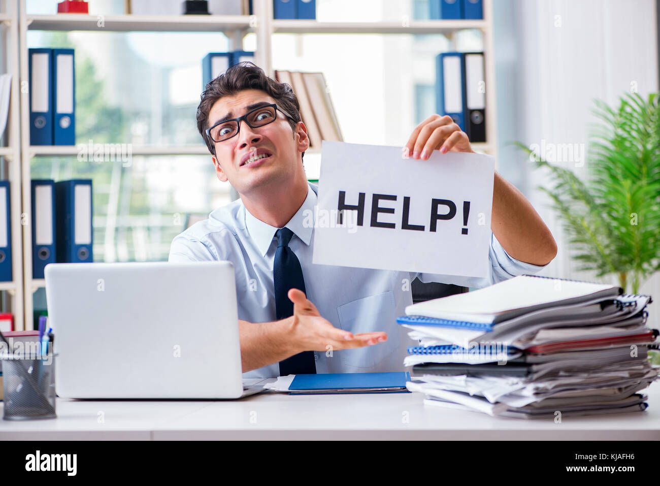 Young businessman asking for help in office Stock Photo - Alamy