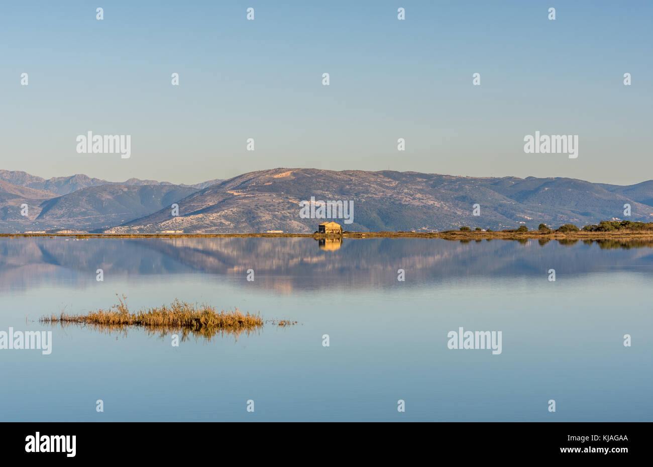 Old salt lake barn reflecting at the Salt marshes of Lefkimmi. Today ...