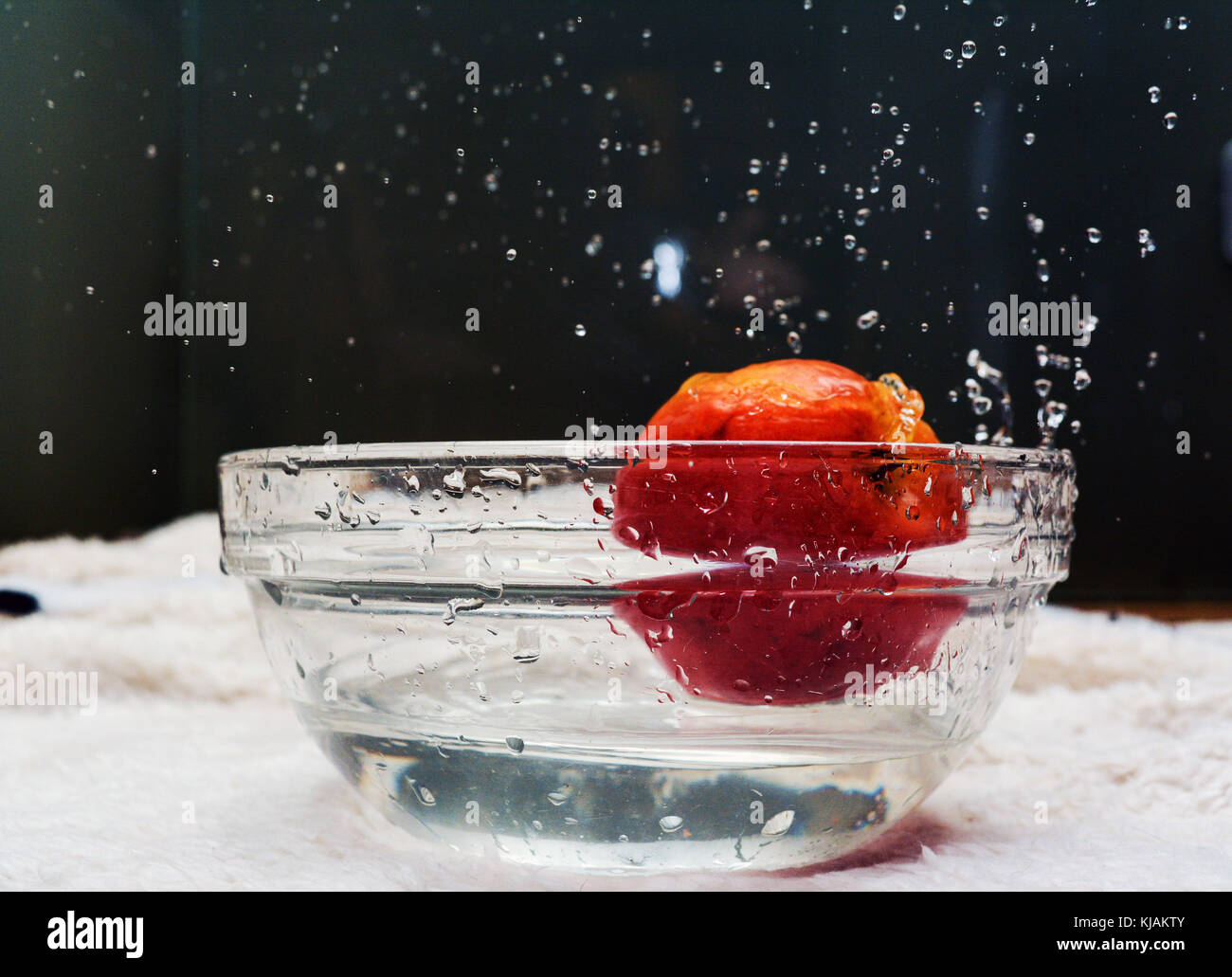 A ripe apple splashing into the water Stock Photo - Alamy