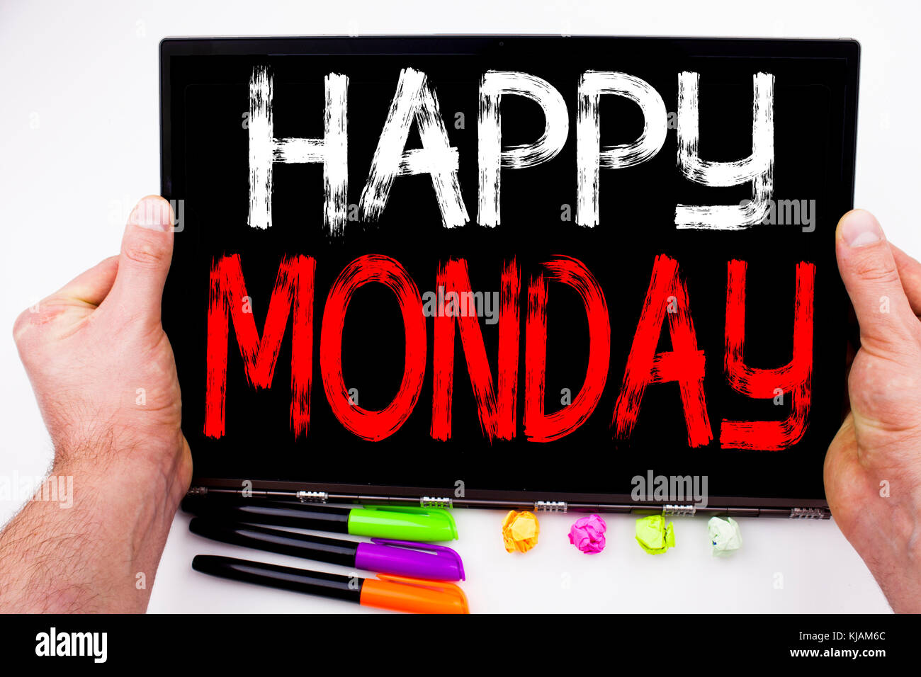 Happy Monday text written on tablet, computer in the office with marker ...