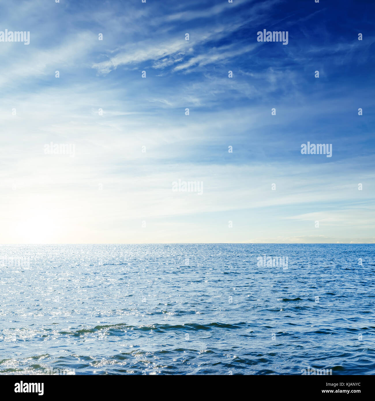 sunset in blue sky over sea Stock Photo - Alamy