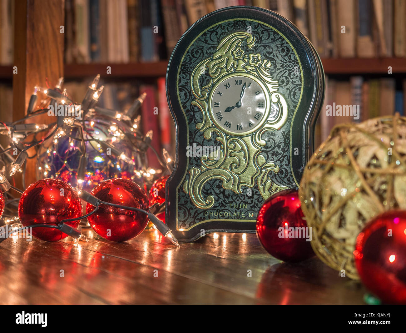 Christmas ornaments, bauble and clock over the background with bookcase ...