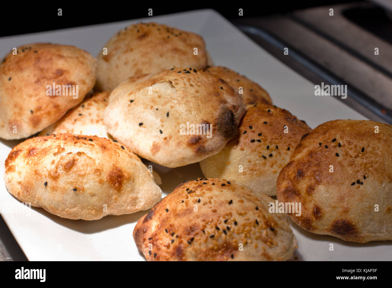 Traditional Turkish flat cake made from thin dough with a sesame Stock ...