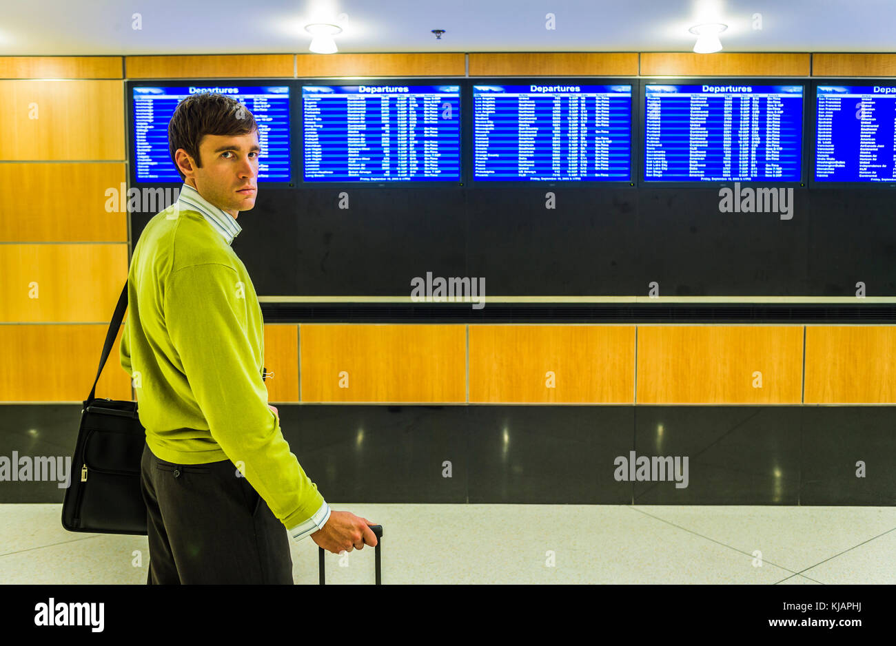 Young man airport departures board hi-res stock photography and images ...