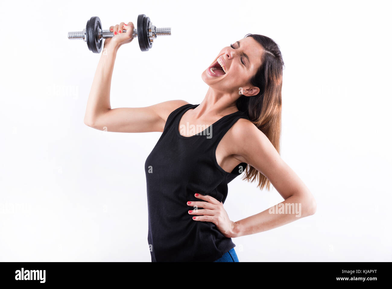 A beautiful young woman lifting weight and screaming Stock Photo - Alamy