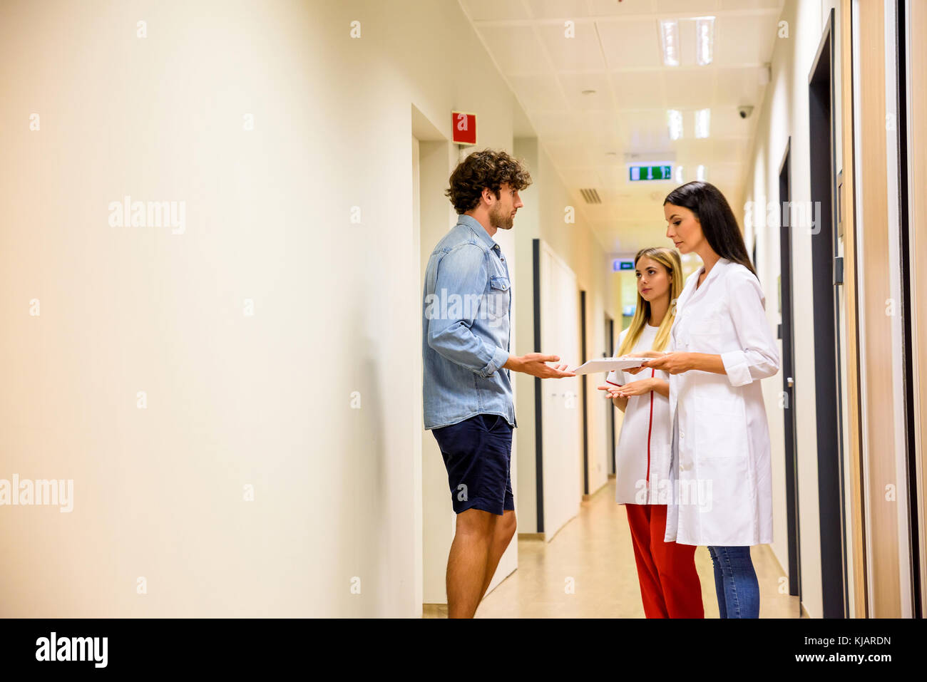 A doctor and a nurse discussing the Diagnosis with the patient or ...