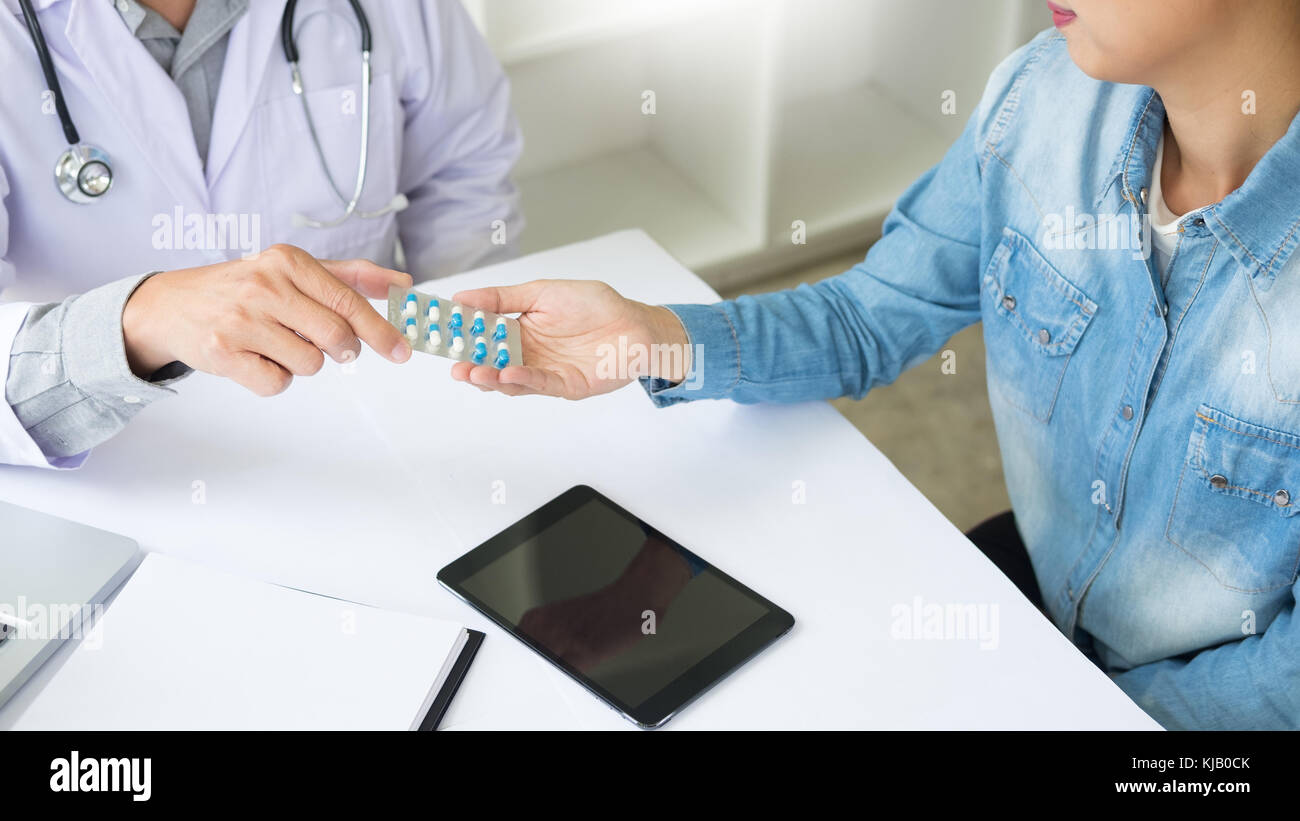 Female doctor hand holding tablet to patient in hospital room Stock ...