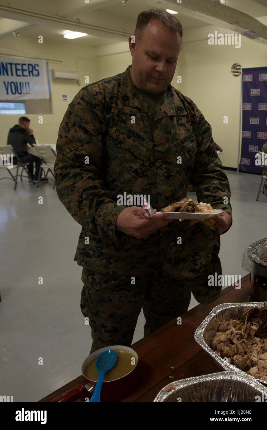 CAMP FOSTER, OKINAWA, Japan – Gunnery Sgt. Anthony Roundy gets food ...