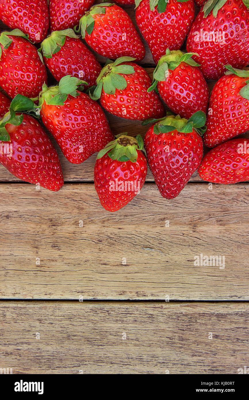 Ripe Organic Strawberries Scattered on Weathered Wood Background ...