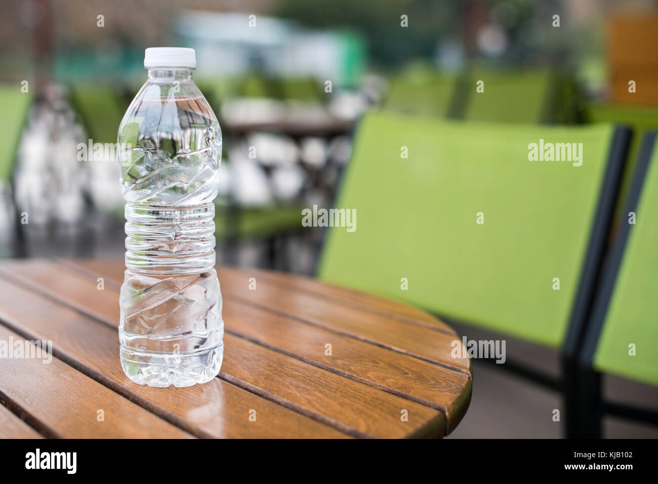 Bottle mineral water on wooden table in restaurant Stock Photo - Alamy