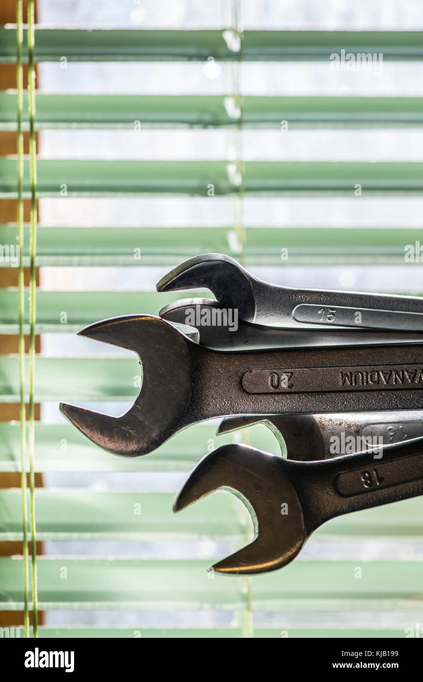Many wrenches on window background Stock Photo - Alamy