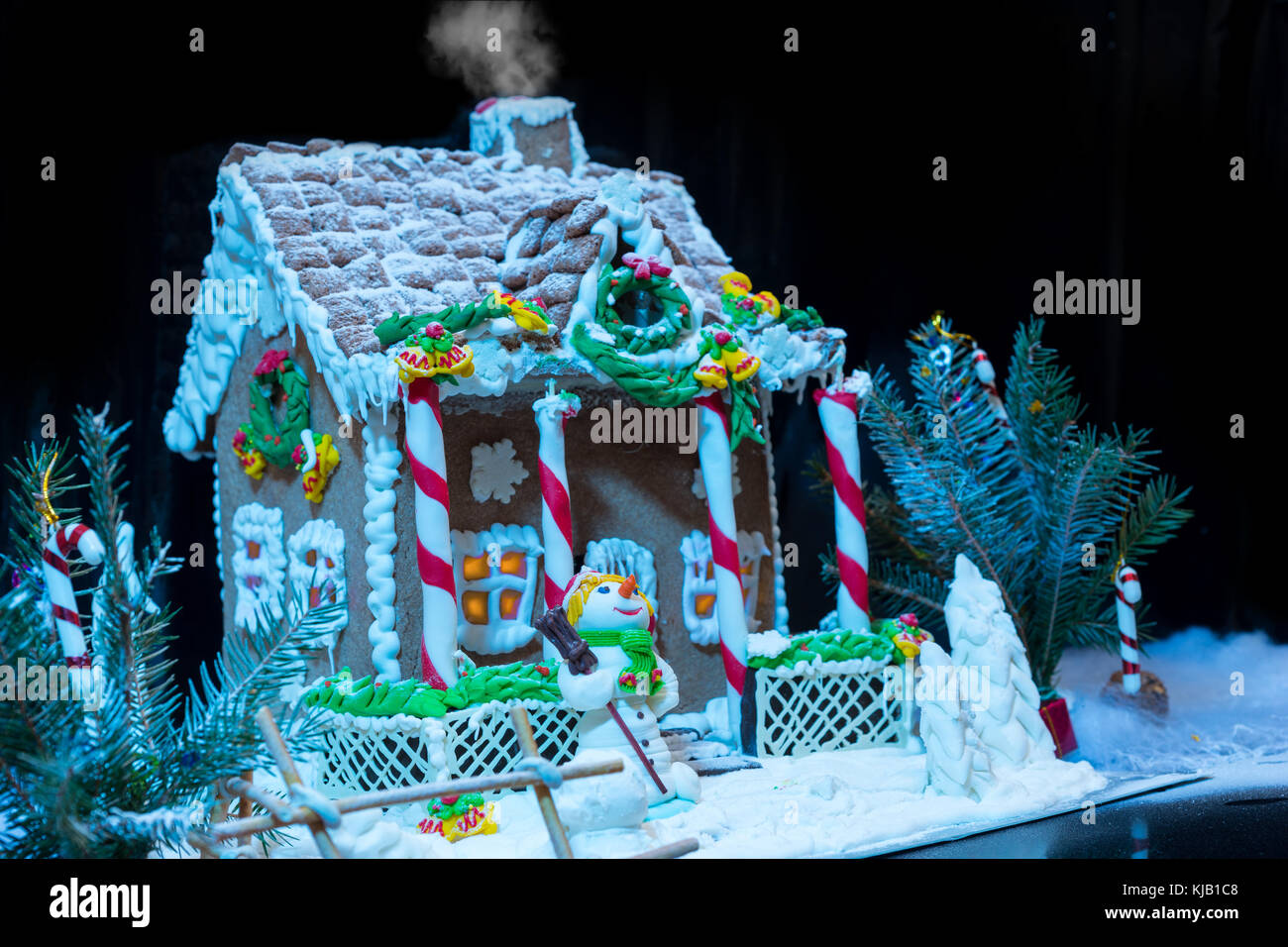 Delicious big gingerbread house with smoke from the chimney, sprig of ...