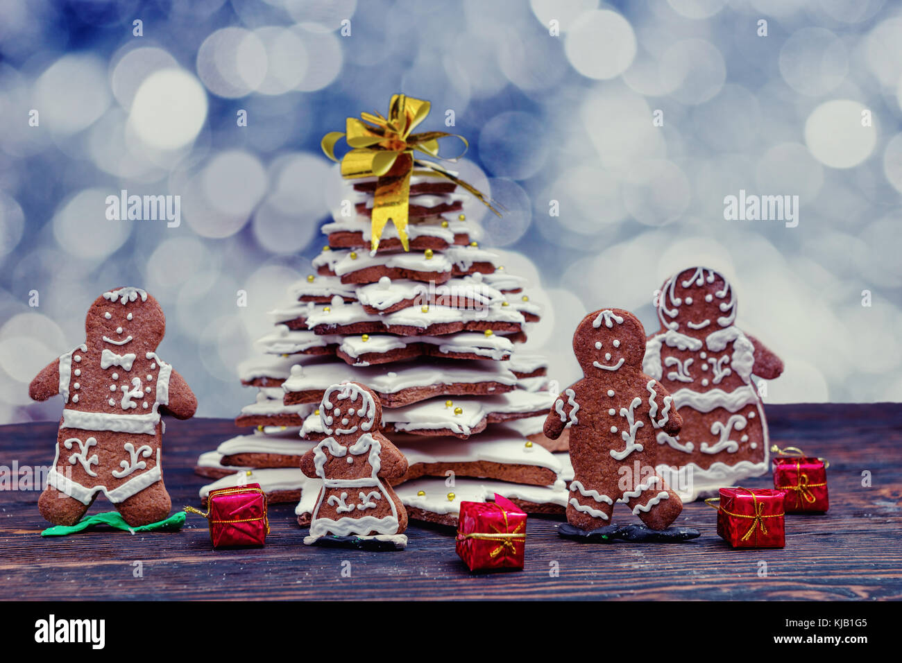 Homemade gingerbread Christmas tree with cute gingerbread family with ...