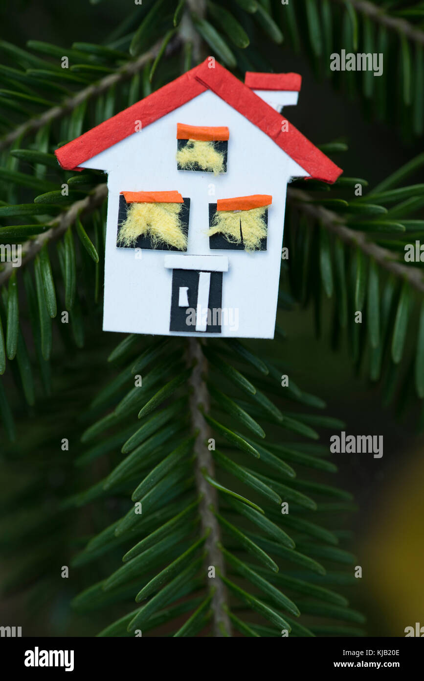 House miniature on fir tree. Paper house Stock Photo - Alamy