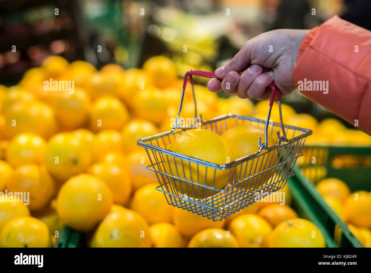 Fruits in supermarket. Buying oranges in shop. Small basket Stock Photo ...