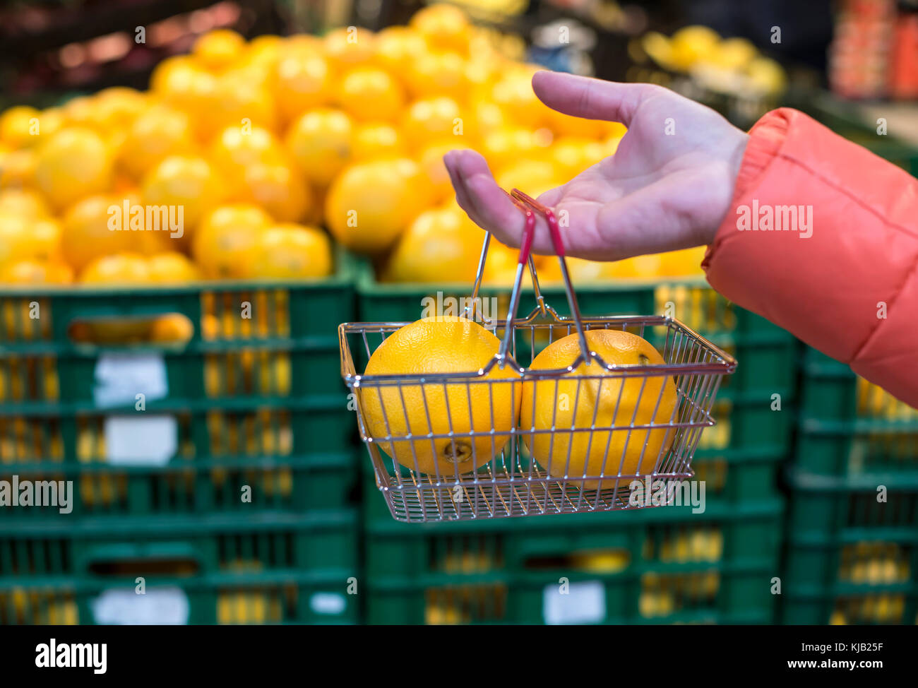 Fruits in supermarket. Buying oranges in shop. Small basket Stock Photo ...