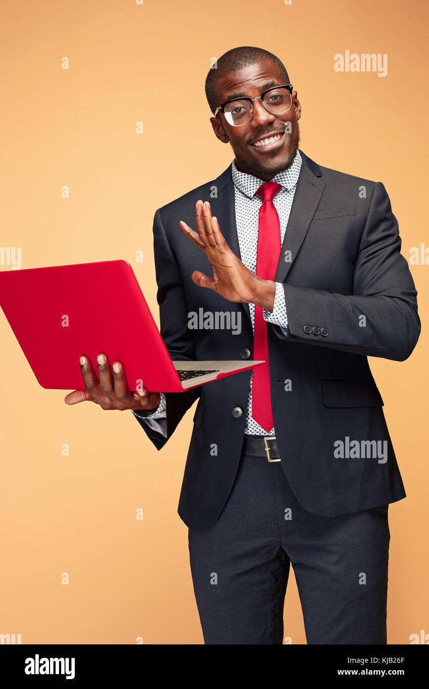 Handsome Afro American man sitting and using a laptop Stock Photo - Alamy