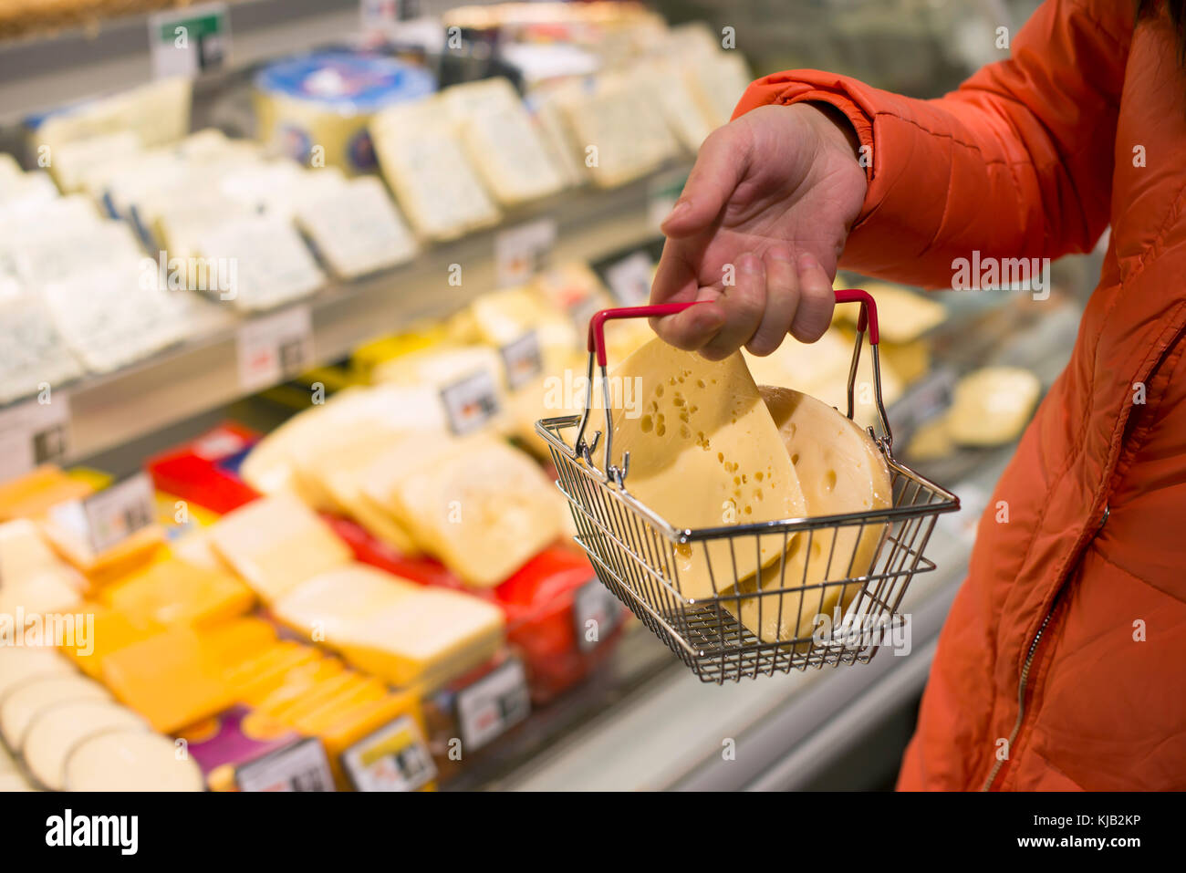 Cheese in supermarket. Buying cheese in shop. Small basket Stock Photo ...